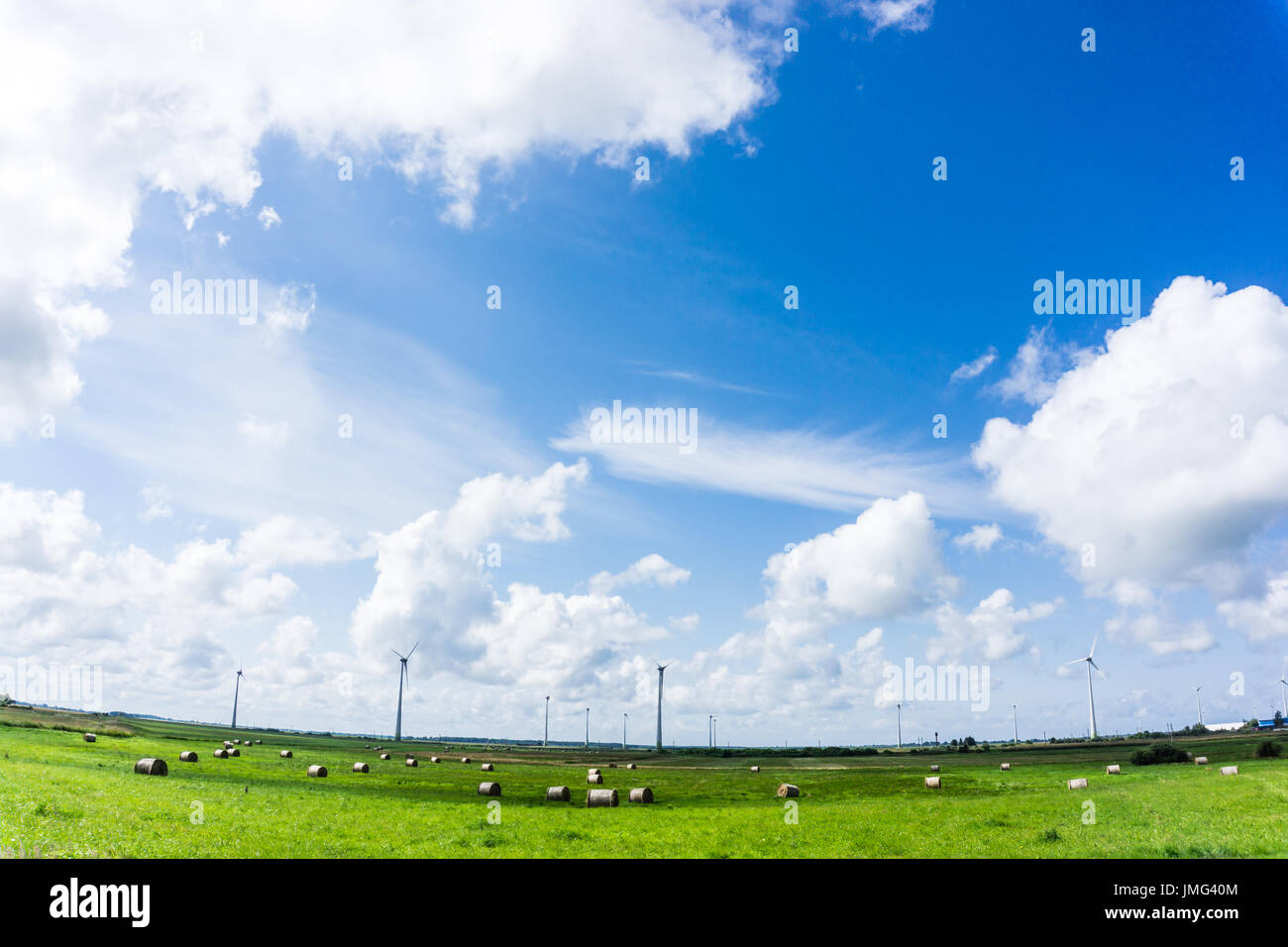 landscape with wind power millls and hay rolls Stock Photo - Alamy