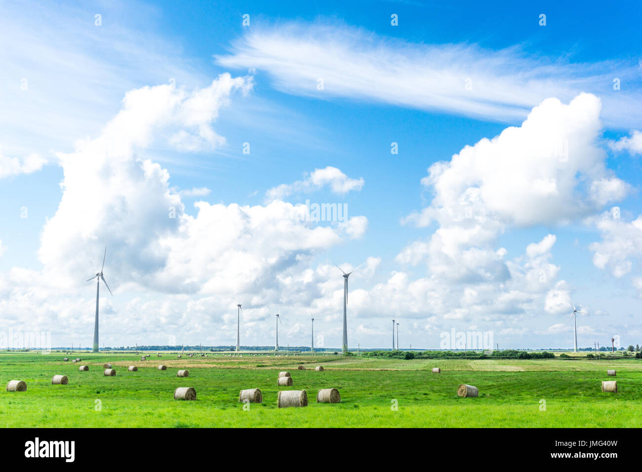 landscape with wind power millls and hay rolls Stock Photo - Alamy