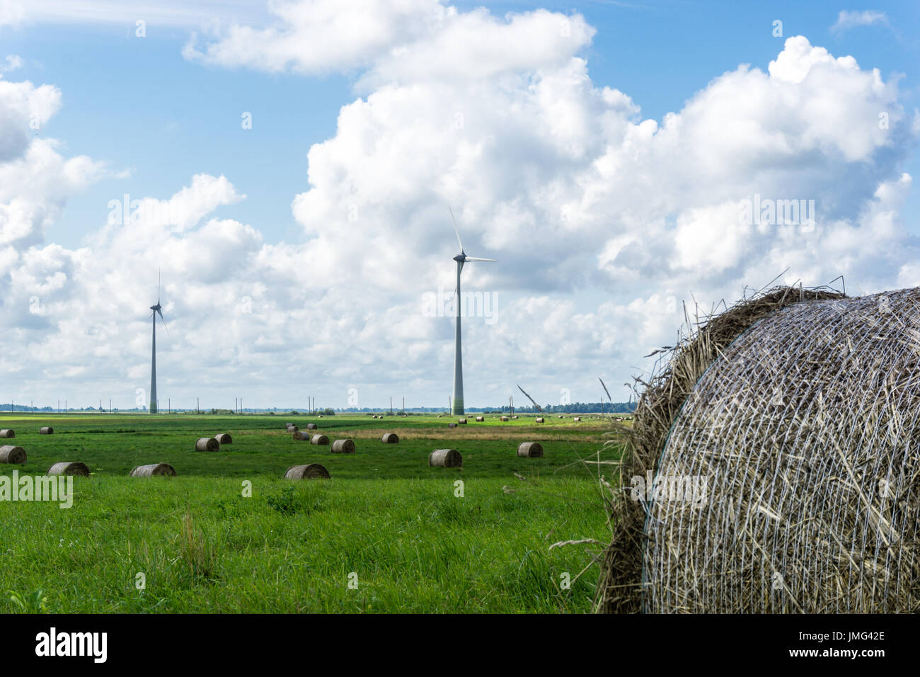 landscape with wind power millls and hay rolls Stock Photo - Alamy