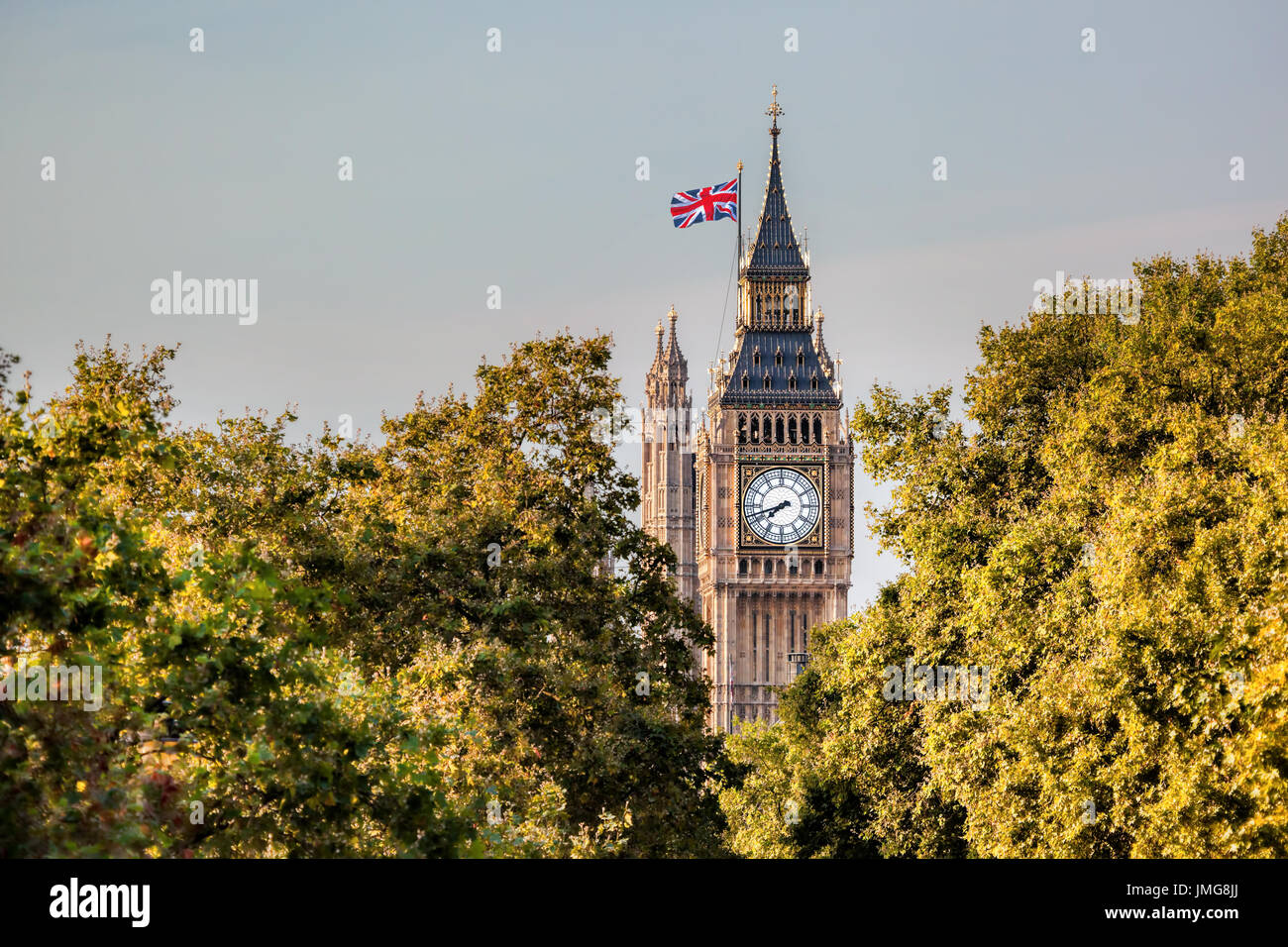 Famous Big Ben clock against trees in London, England, UK Stock Photo ...