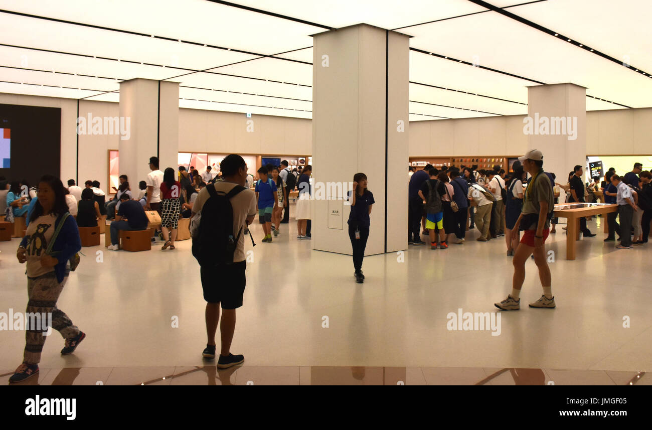 People explore the tech at the grand opening of the 1st Apple ...