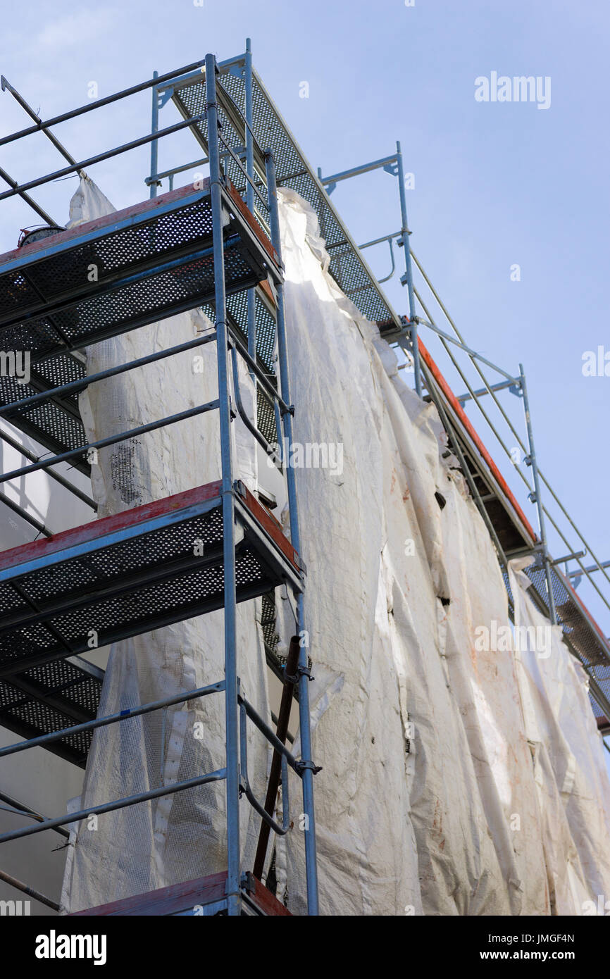 Renovated Building with Scarfold covered with material Stock Photo - Alamy