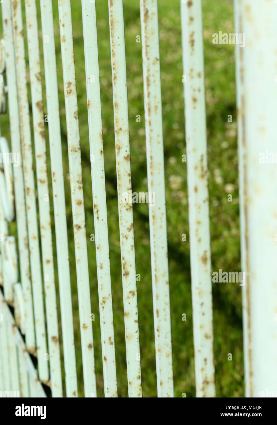 Texture of old rusty metal fence isolated over the green grass ...