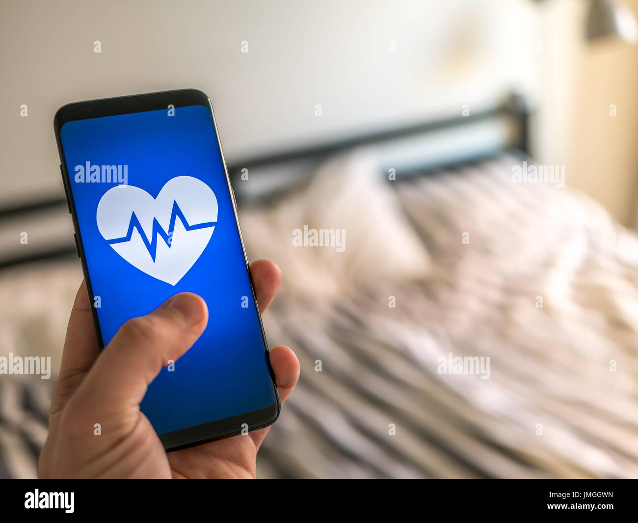 Hand holds a mobile phone with an health care app at home Stock Photo ...