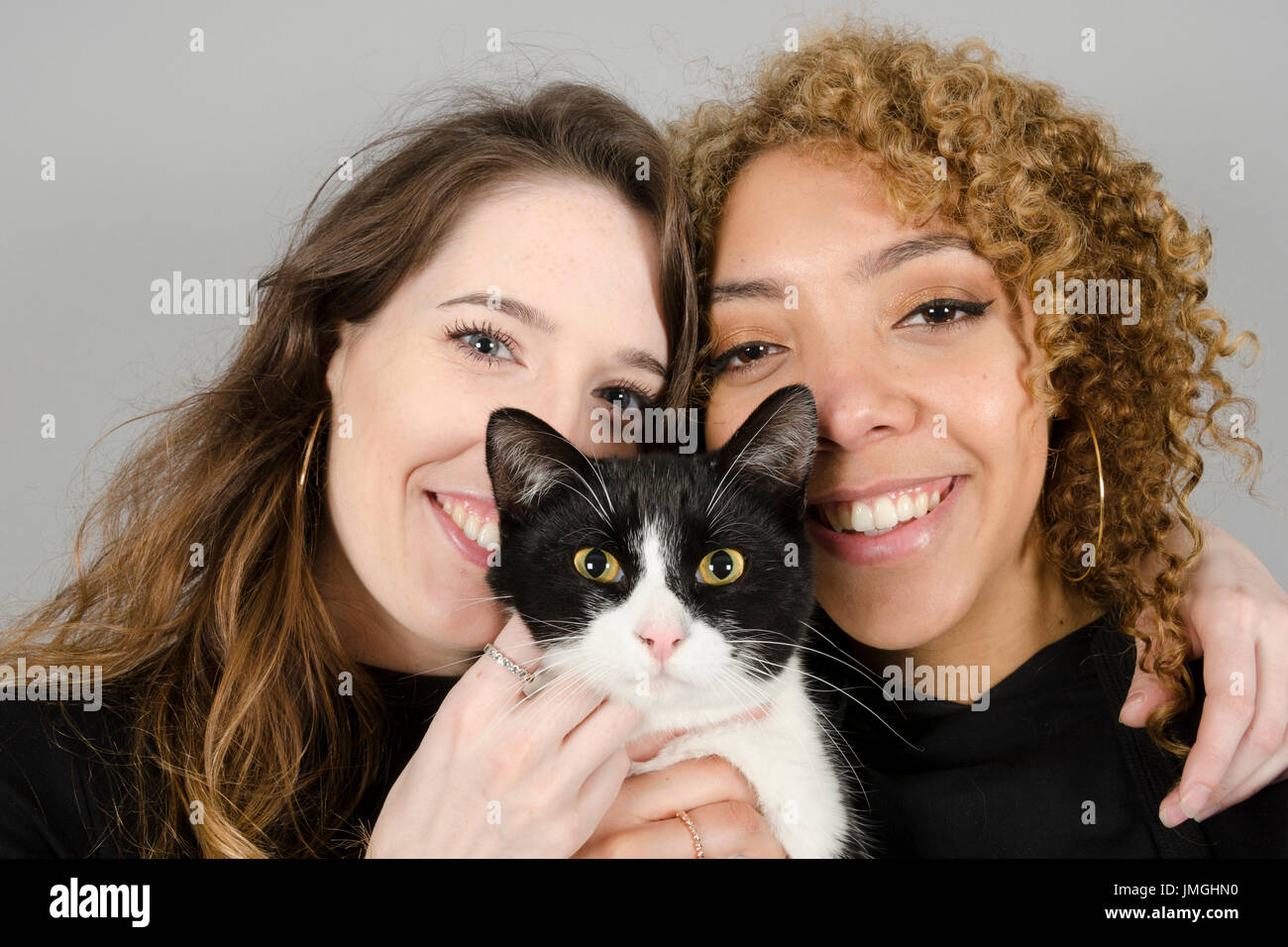 Two young women and their cat, UK Stock Photo - Alamy