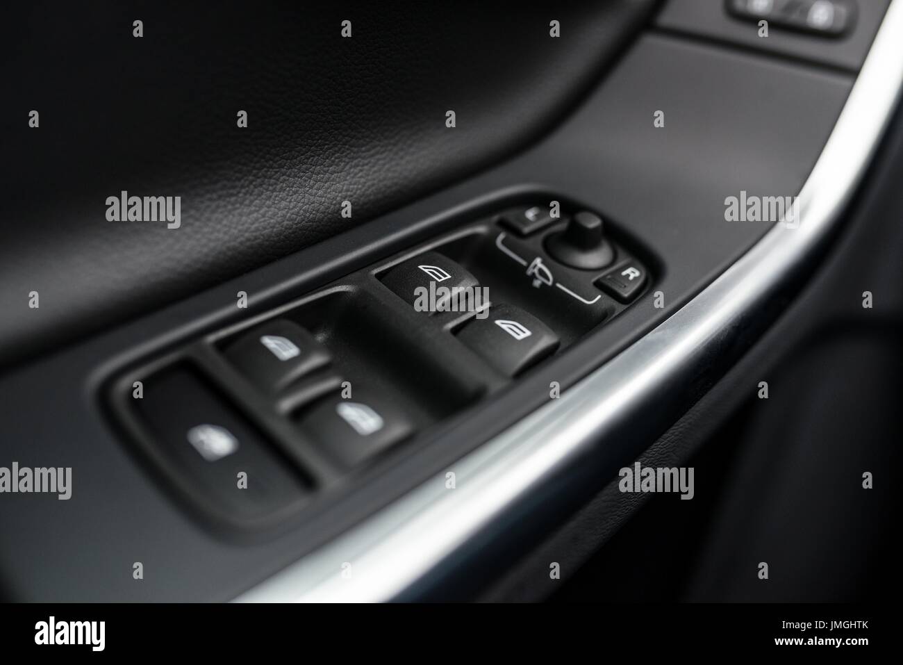 Close-up on power windows and mirrors control buttons in modern car ...