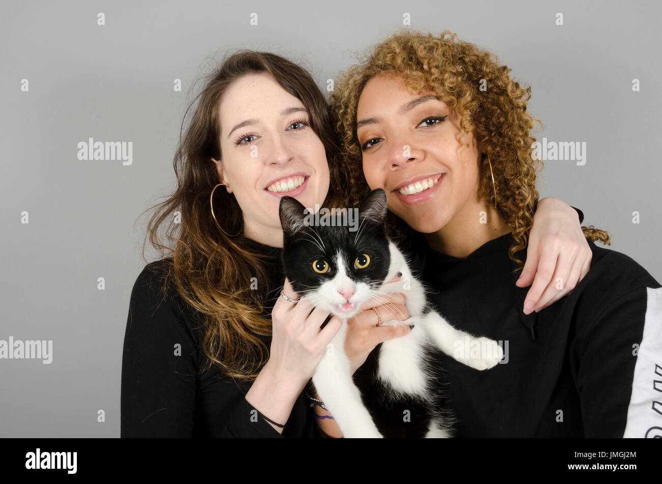 Two young women and their cat, UK Stock Photo - Alamy