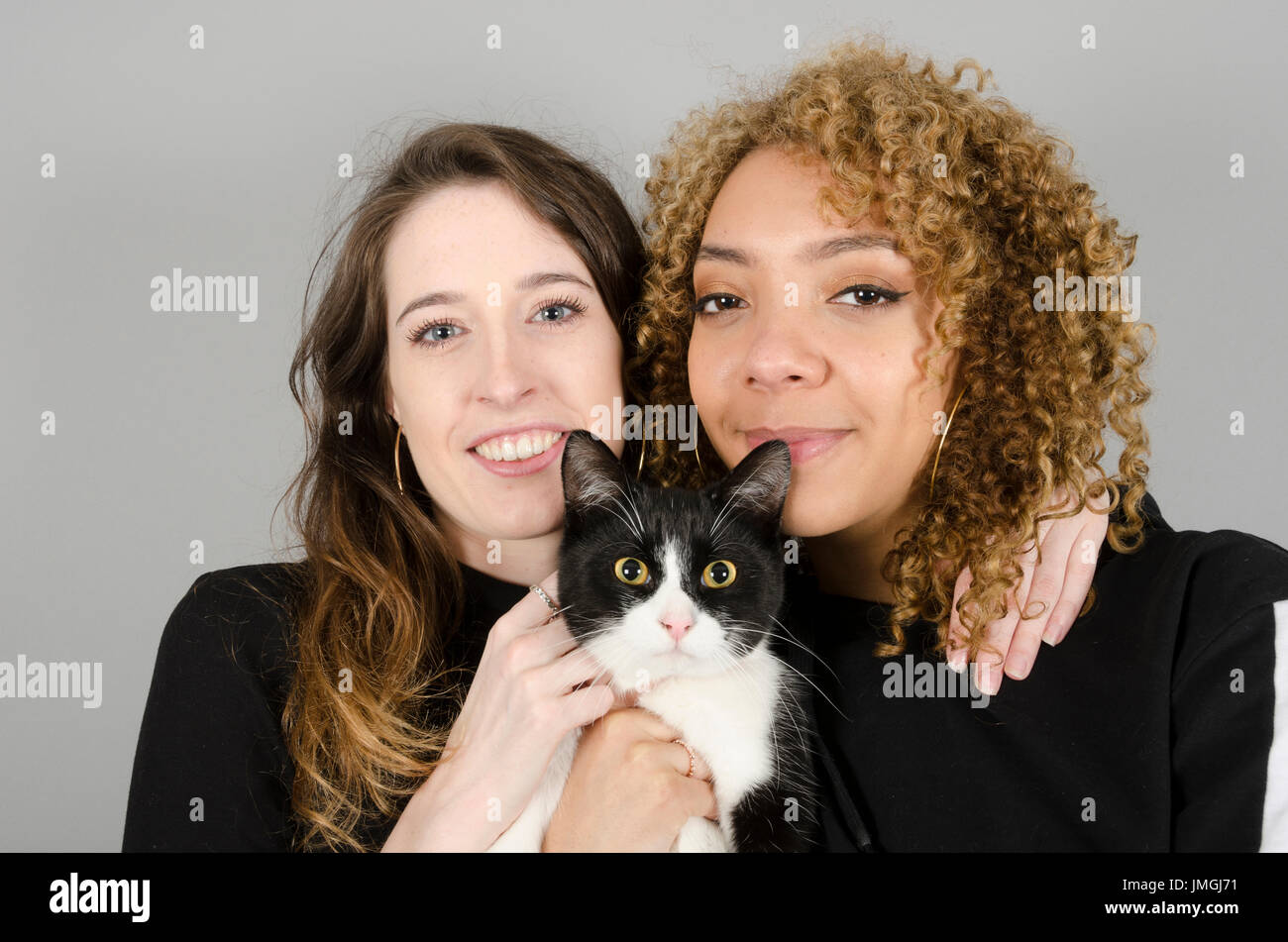 Two young women and their cat, UK Stock Photo - Alamy