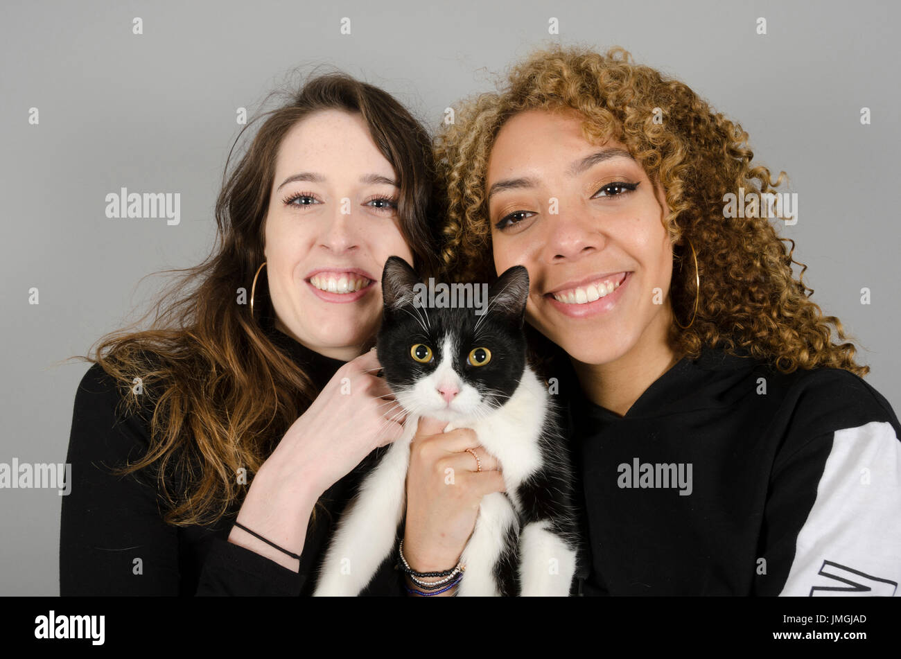 Two young women and their cat, UK Stock Photo - Alamy
