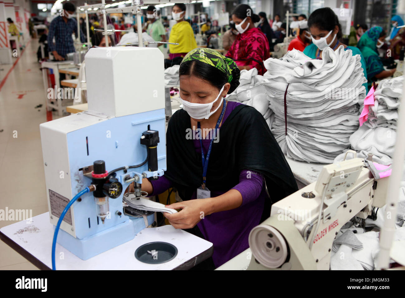 Workers in a ready-made garment factory at Narayanganj on the outskirts ...