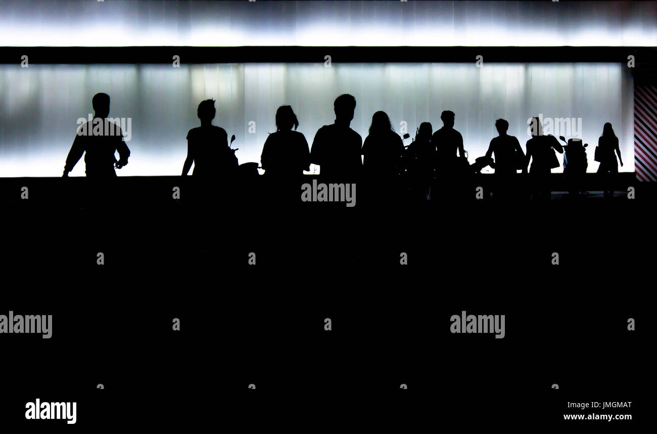 Silhouettes of young people getting out of the building Stock Photo - Alamy