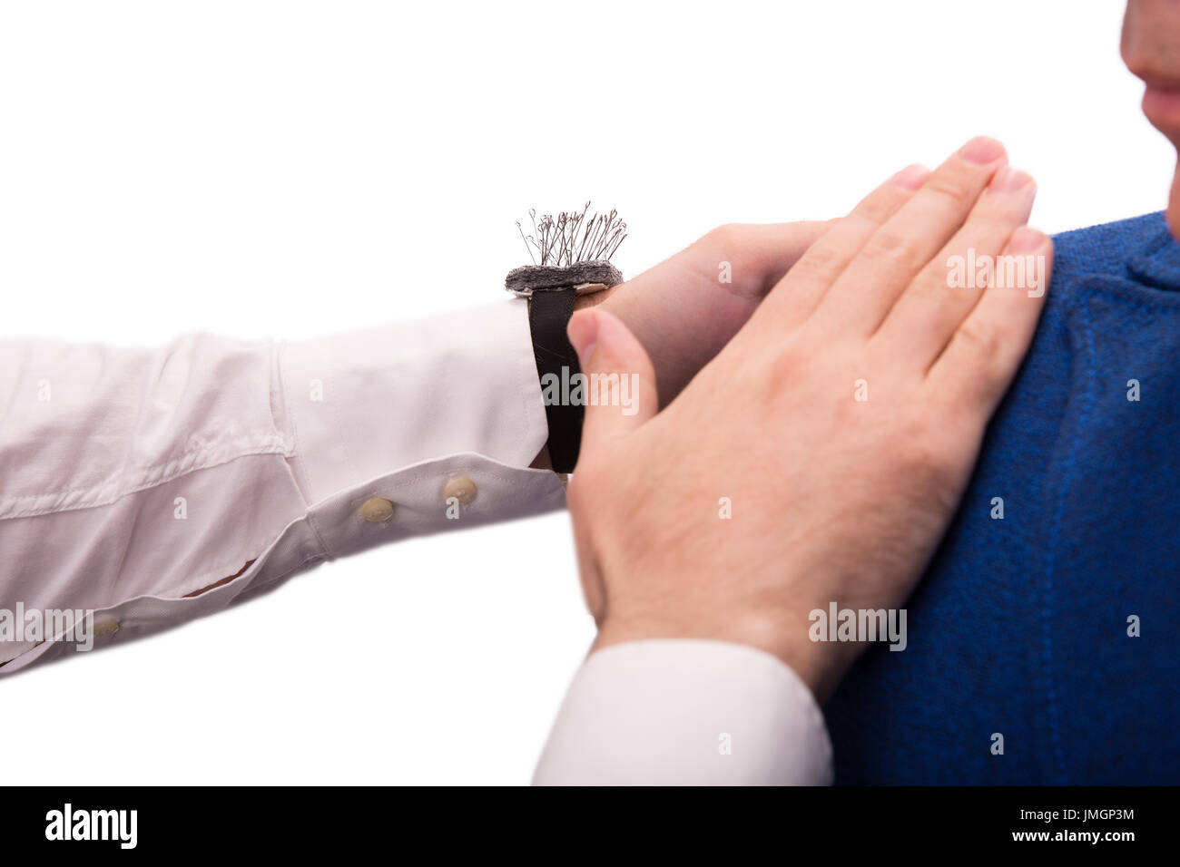male tailor designer make marks on a jacket during bespoke suit fitting ...