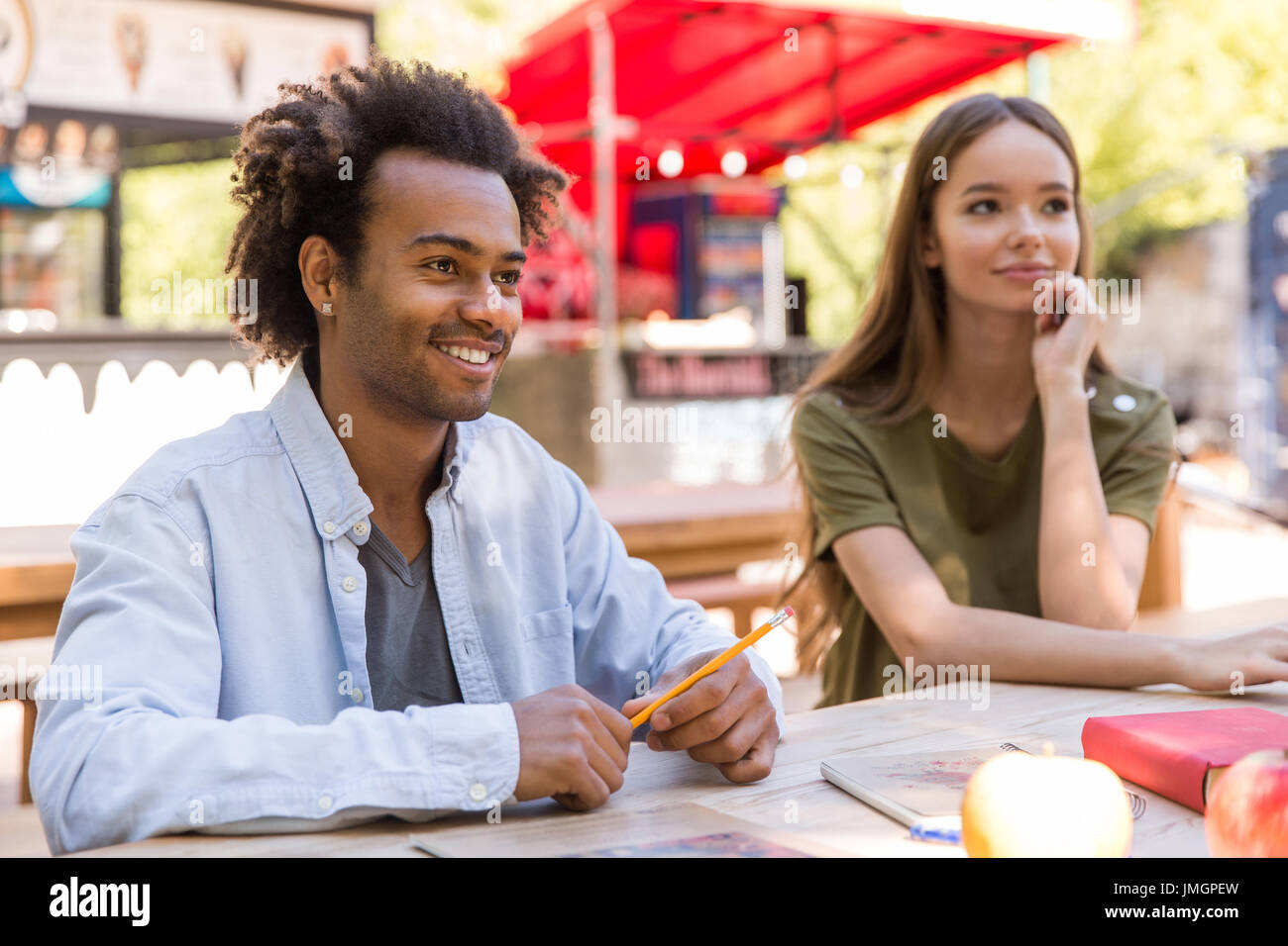 Picture of cheerful young multiethnic group of friends students talking ...