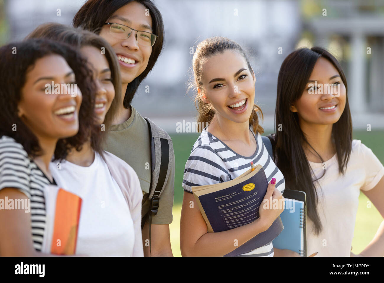 Picture of multiethnic group of young happy students standing outdoors ...