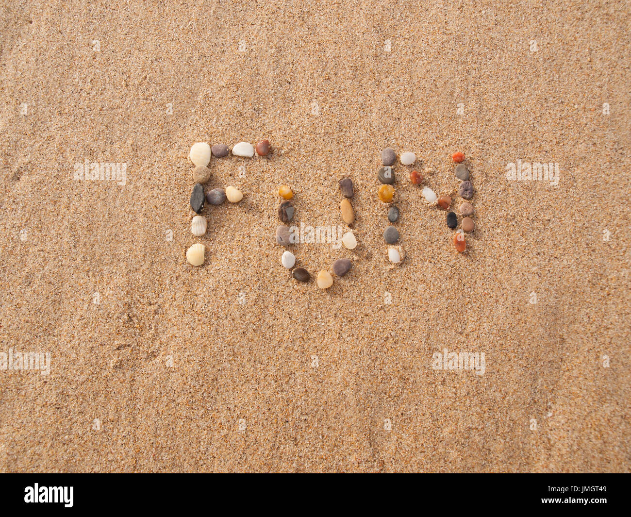 word fun written with stones and shells on the beach by the ocean Stock ...