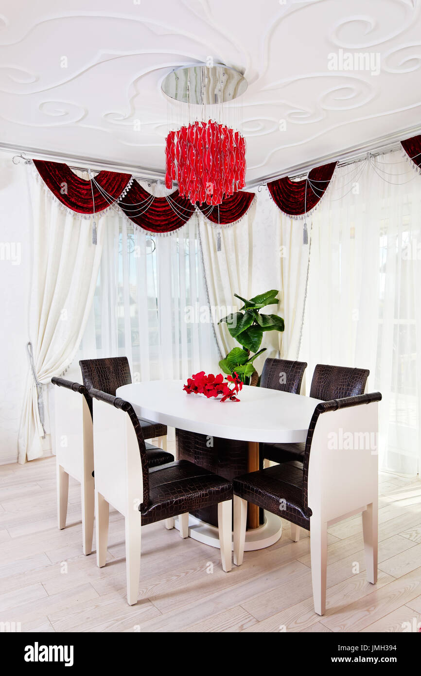 White glossy table with leather chairs in white classical interior ...