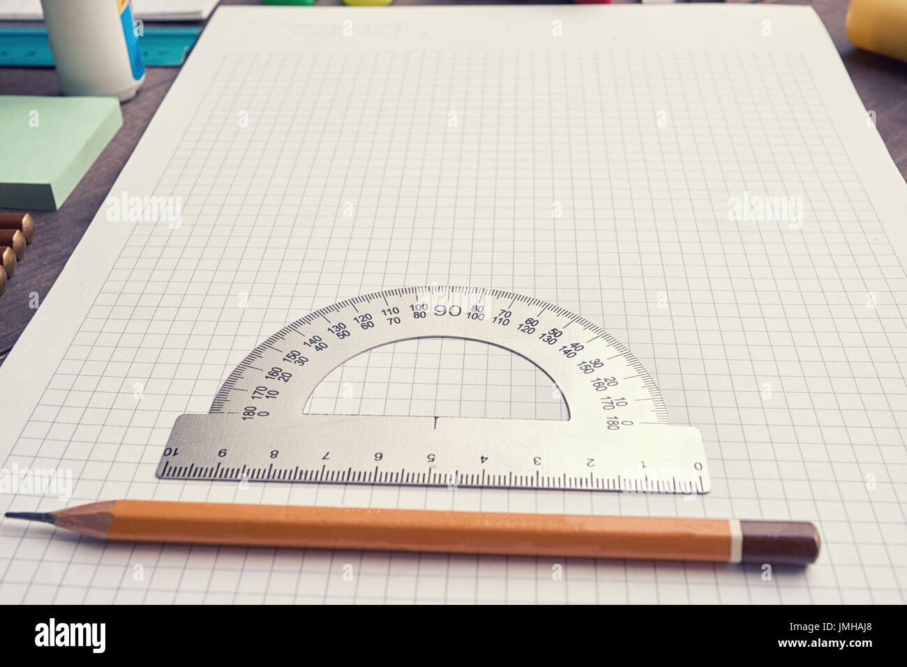 school copybook with square lined with pencil and protractor. low angle ...