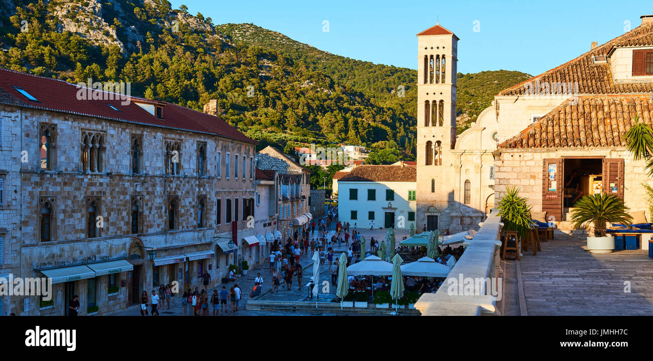 Tourists in Hvar harbor during amazing sunset in old town Hvar. Main ...
