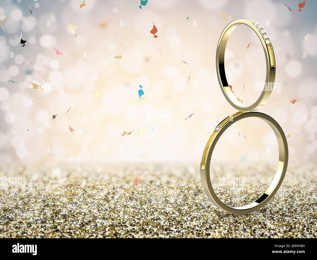 golden wedding rings on gold glitter background Stock Photo - Alamy