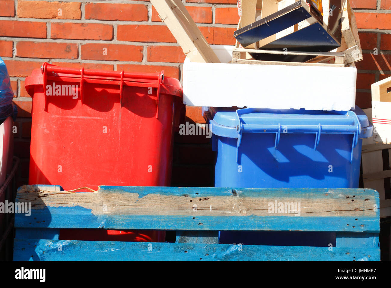 red and blue recycling bins for glass and paper Stock Photo - Alamy