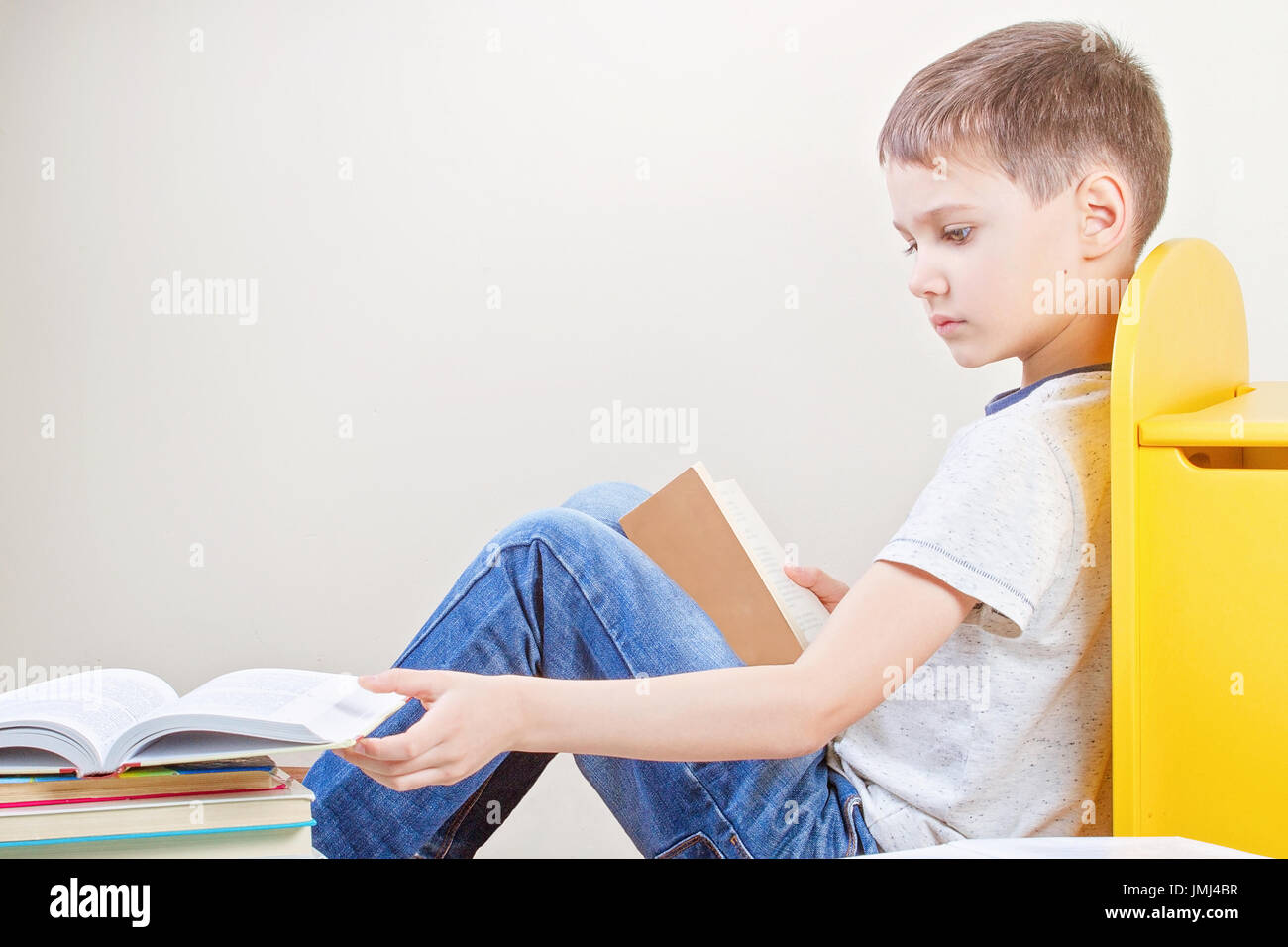Child reading books at home Stock Photo - Alamy