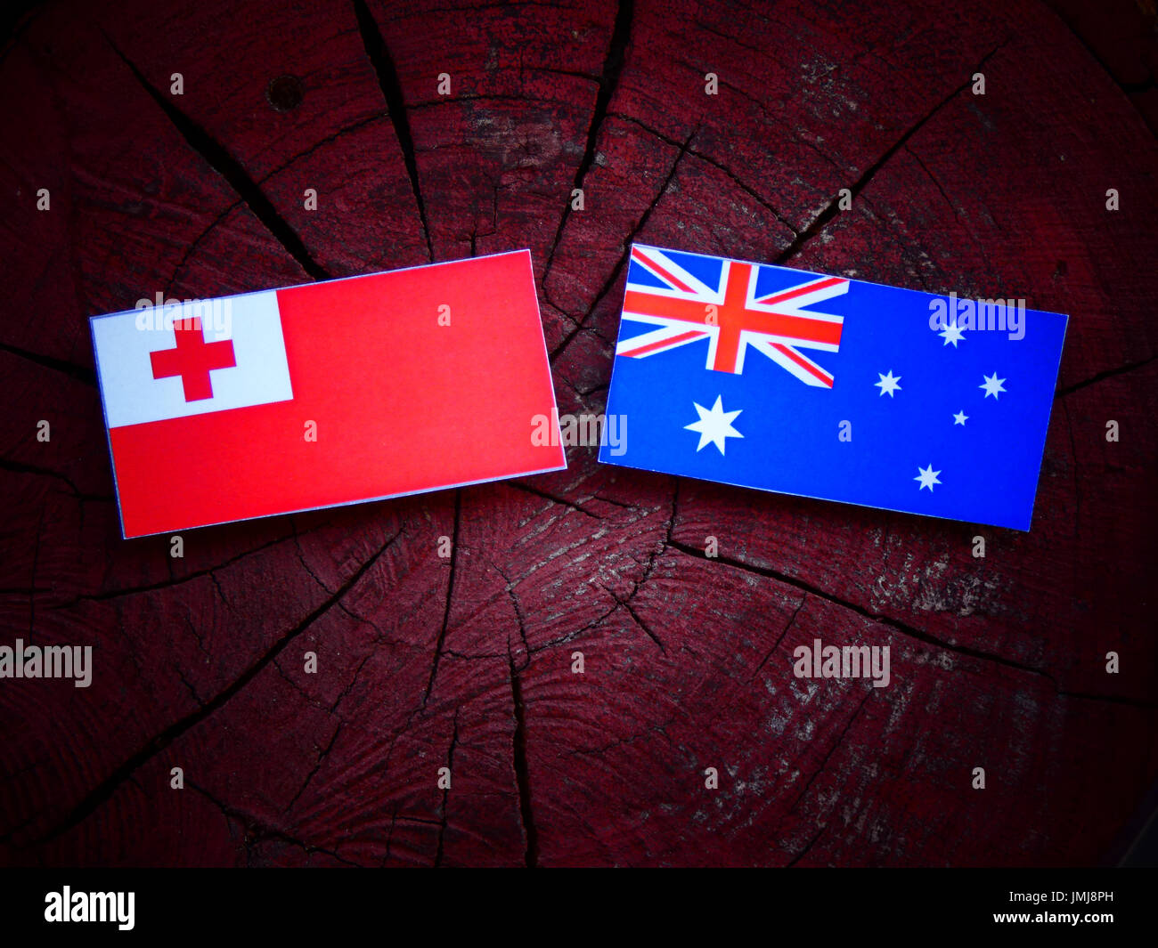 Tongan flag with Australian flag on a tree stump isolated Stock Photo ...