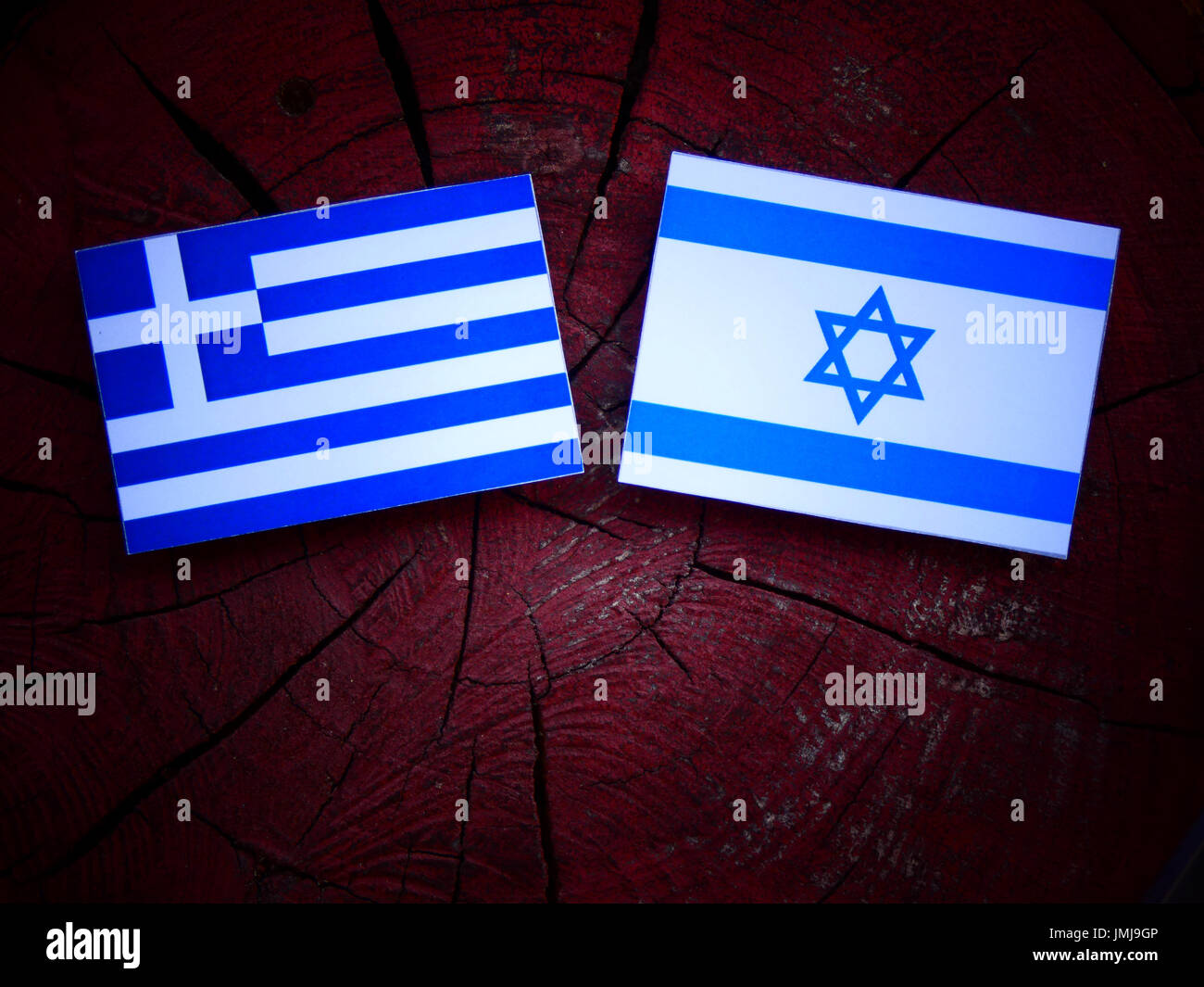 Greek flag with Israeli flag on a tree stump isolated Stock Photo - Alamy
