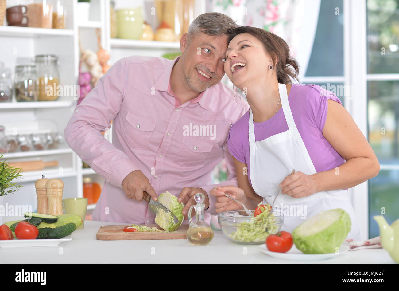 Happy lovely couple cooking hi-res stock photography and images - Alamy