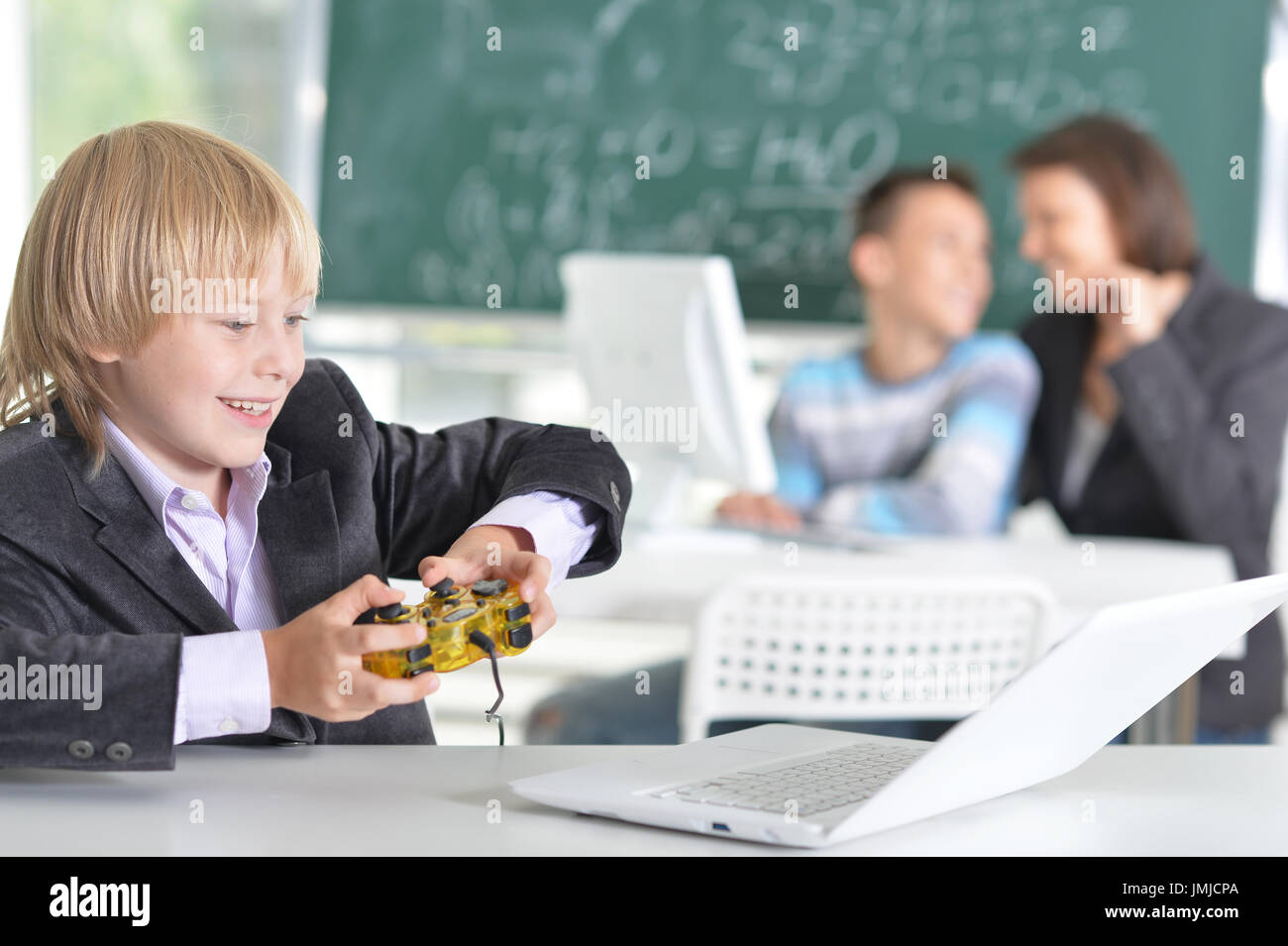 Portrait of a cute little boy playing computer games Stock Photo - Alamy