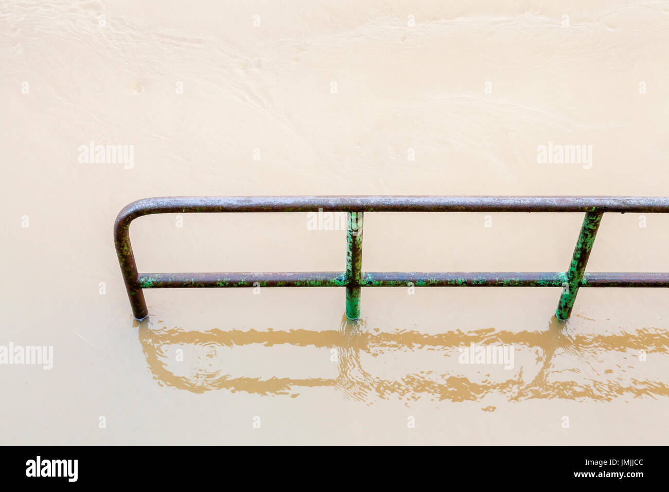 Flooding UK. Railings in muddy flood water, Nottingham, England, UK ...