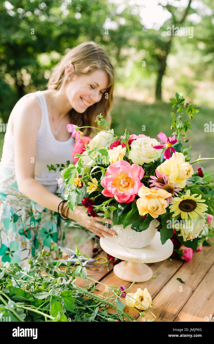 bouquet, people and floral arrangement concept - smiling young woman ...