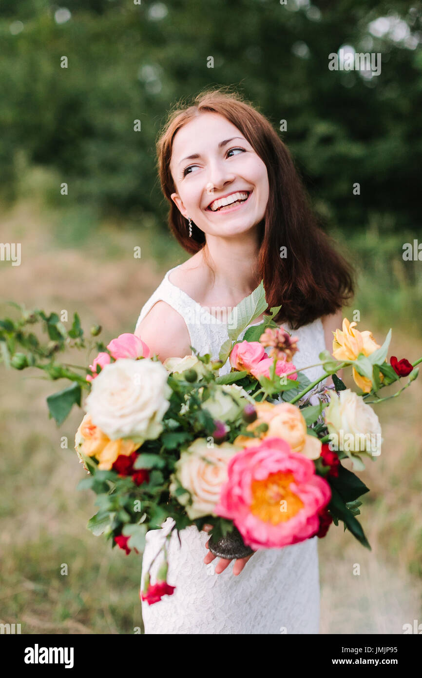 bouquet, people and floral arrangement concept - young smiling woman ...