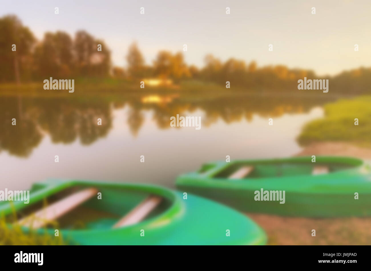 Abstract blurred image of a natural lake and boats to use the ...