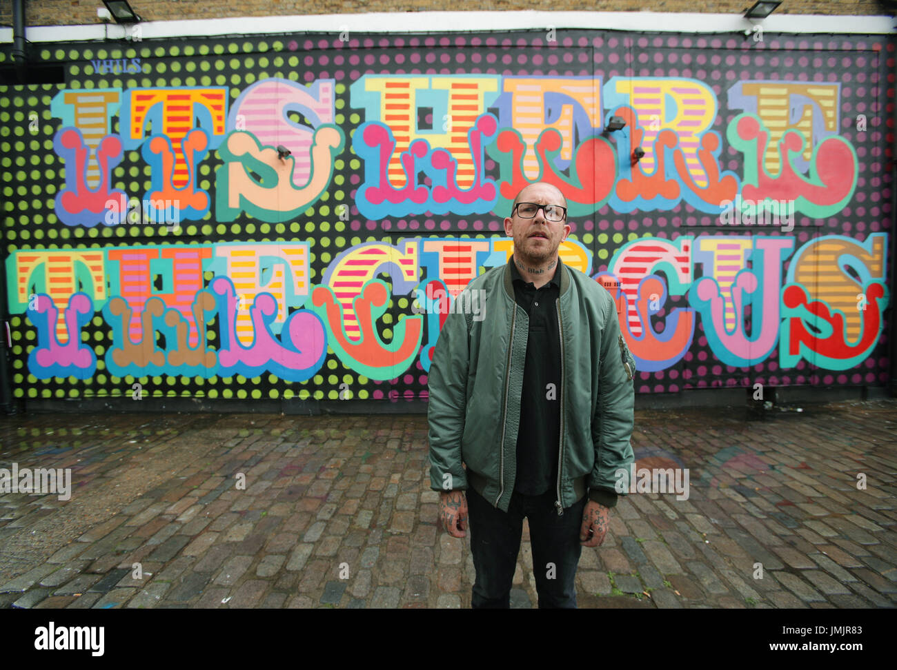 Street artist Ben Eine putting the finishing touches to his work 'Its ...