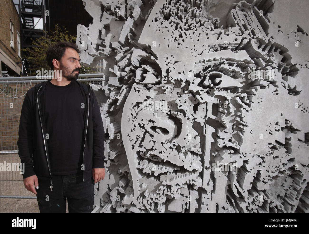 Portugese artist Vhils stands next to his installation 'Diorama' during ...