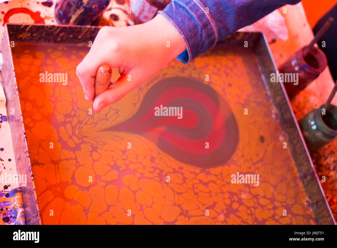 Hand drawing with stick stained inks on water surface Stock Photo - Alamy