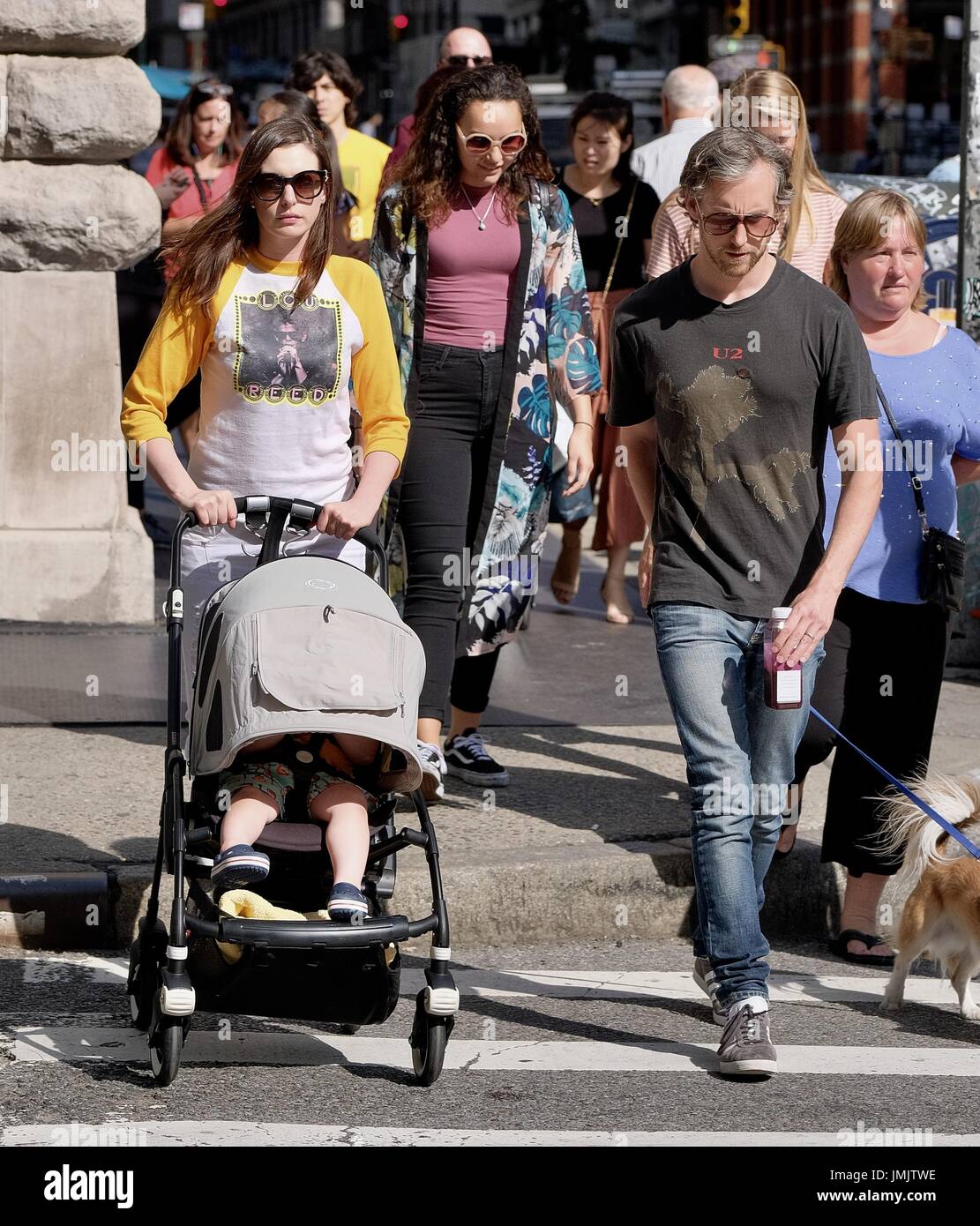 Anne Hathaway and Adam Shulman walking with their child in SOHO ...
