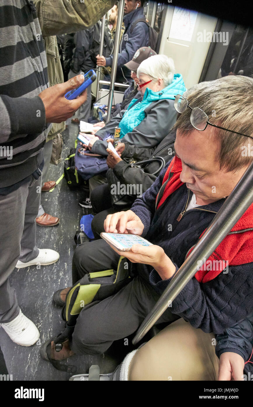 passengers using smartphones inside train on Boston MBTA underground ...