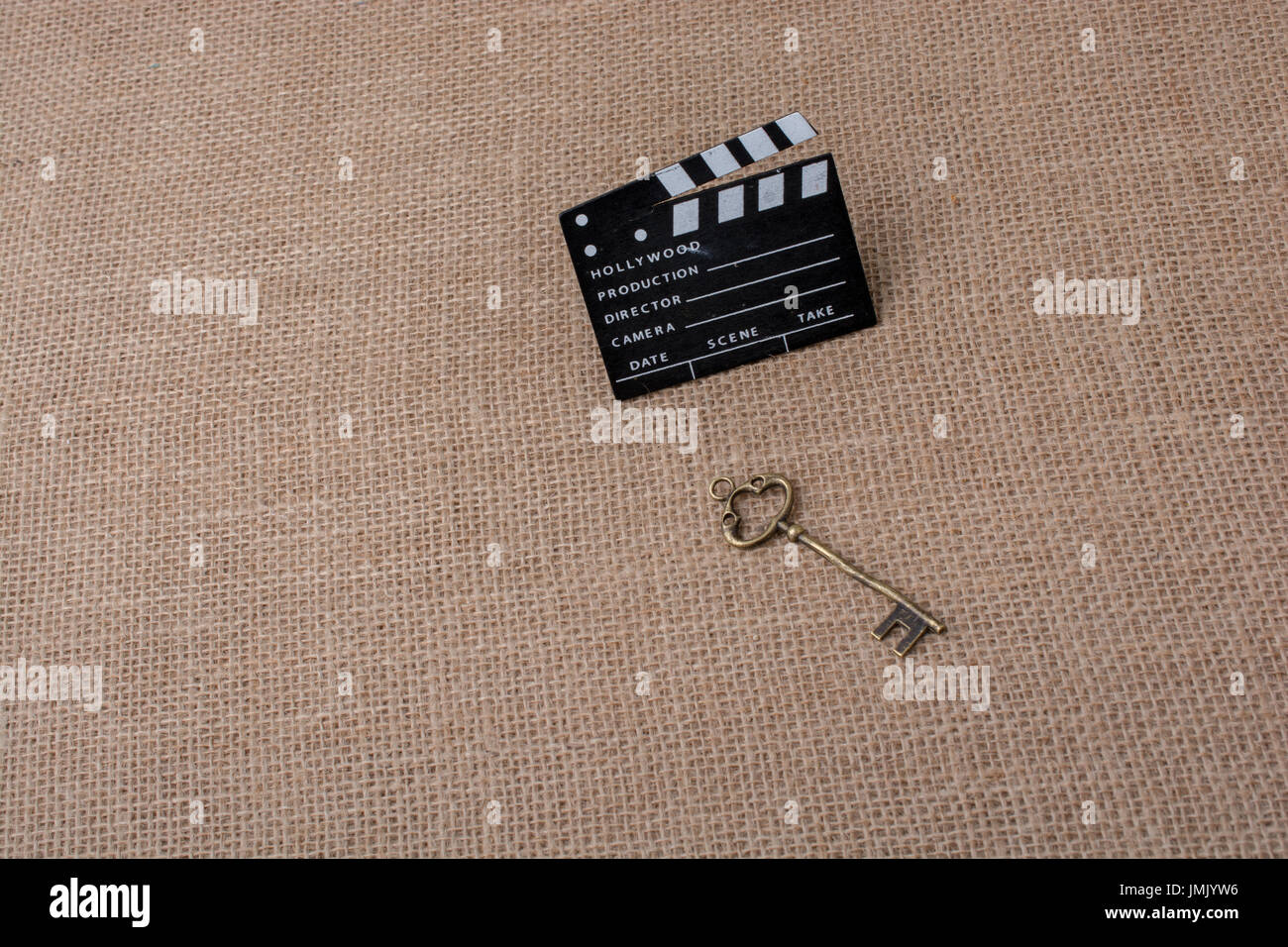 Movie clapper and retro key on canvas background Stock Photo - Alamy