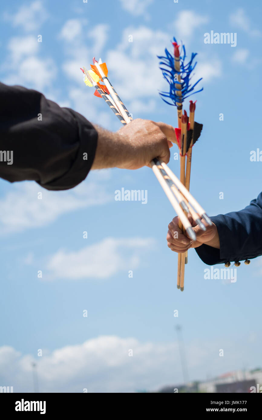 Hand holding old style wooden arrows Stock Photo - Alamy