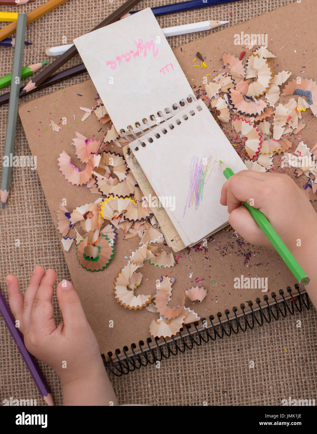 Hand holding a color pencil on spiral notebooks with pencil trash Stock ...