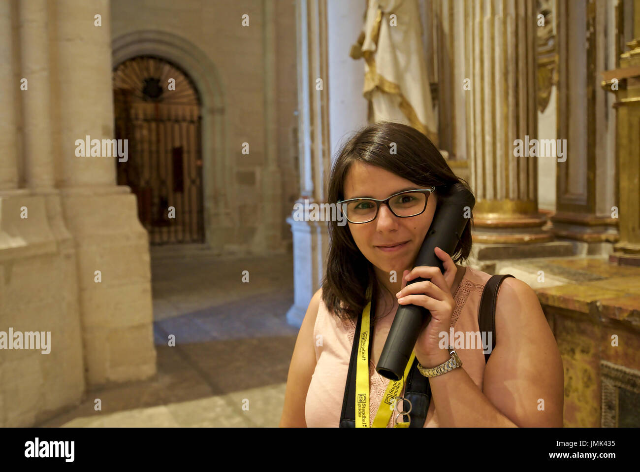 Tourist listens to an audio guide in the cathedral of Cuenca, Castilla ...