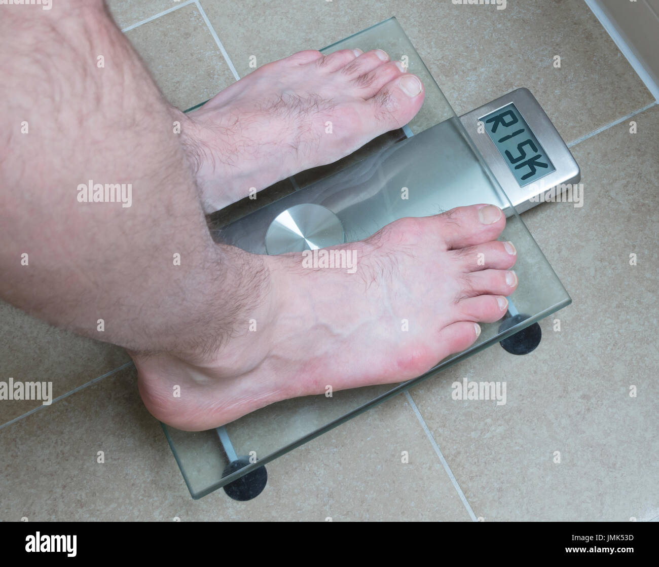 Closeup of man's feet on weight scale - Risk Stock Photo - Alamy