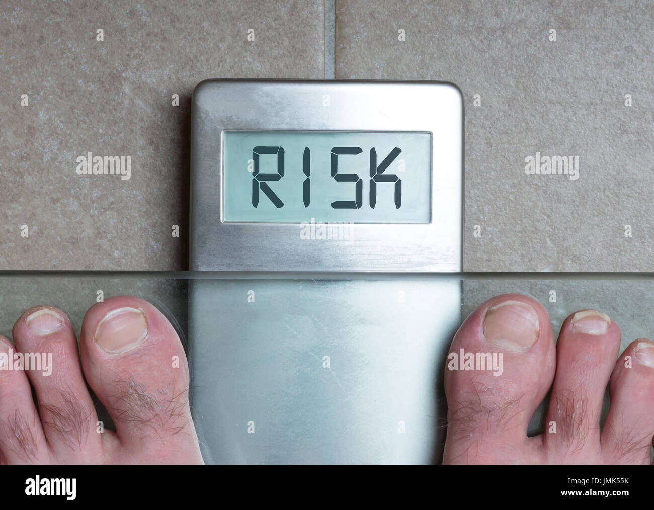 Closeup of man's feet on weight scale - Risk Stock Photo - Alamy