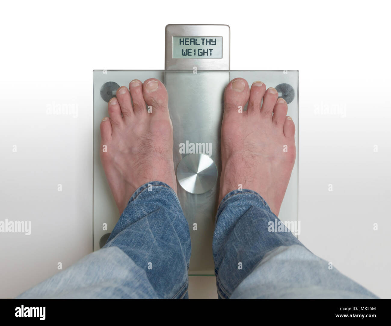 Closeup of man's feet on weight scale - Healthy weight Stock Photo - Alamy