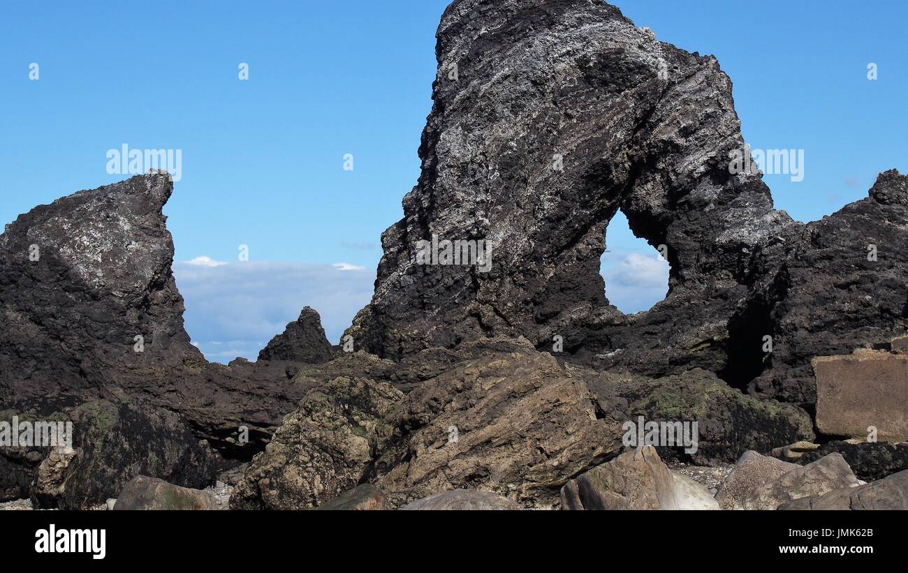 Wave cut industrial slag arch, North Beach Workington, Cumbria, United ...