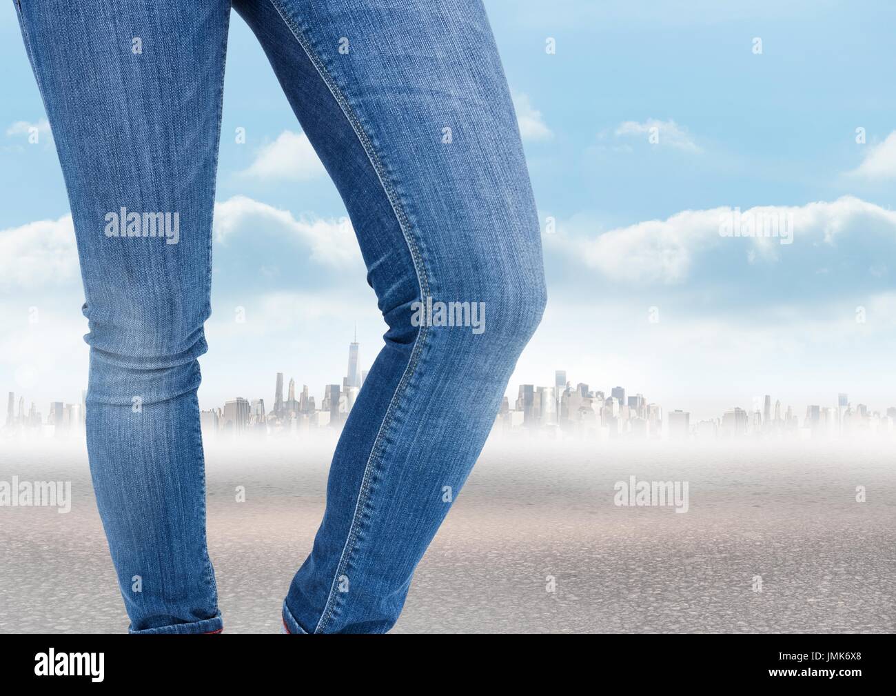 Digital composite of Woman's legs in front of city landscape in jeans ...