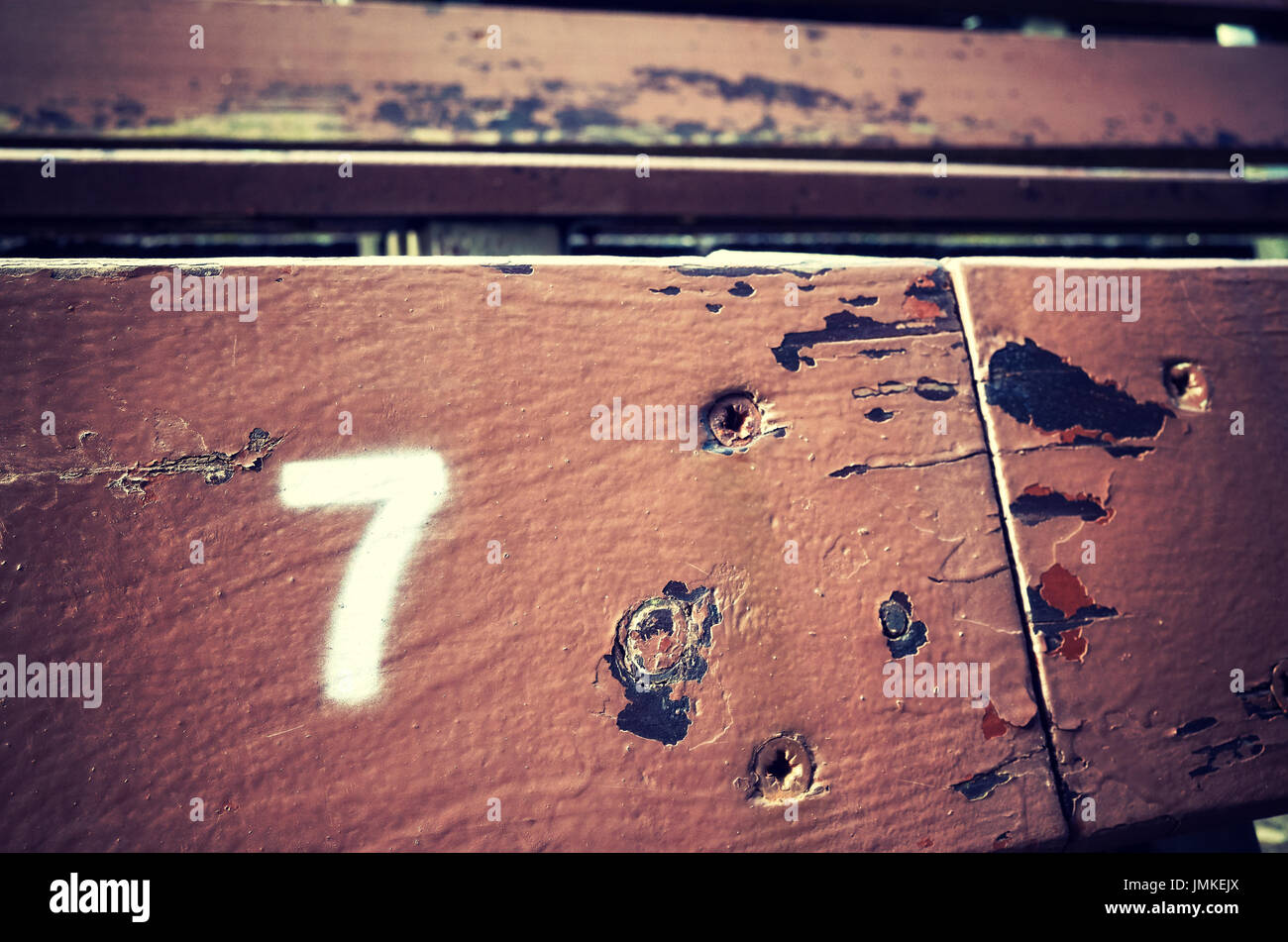 Number seven painted on an old wooden seat, conceptual picture with ...