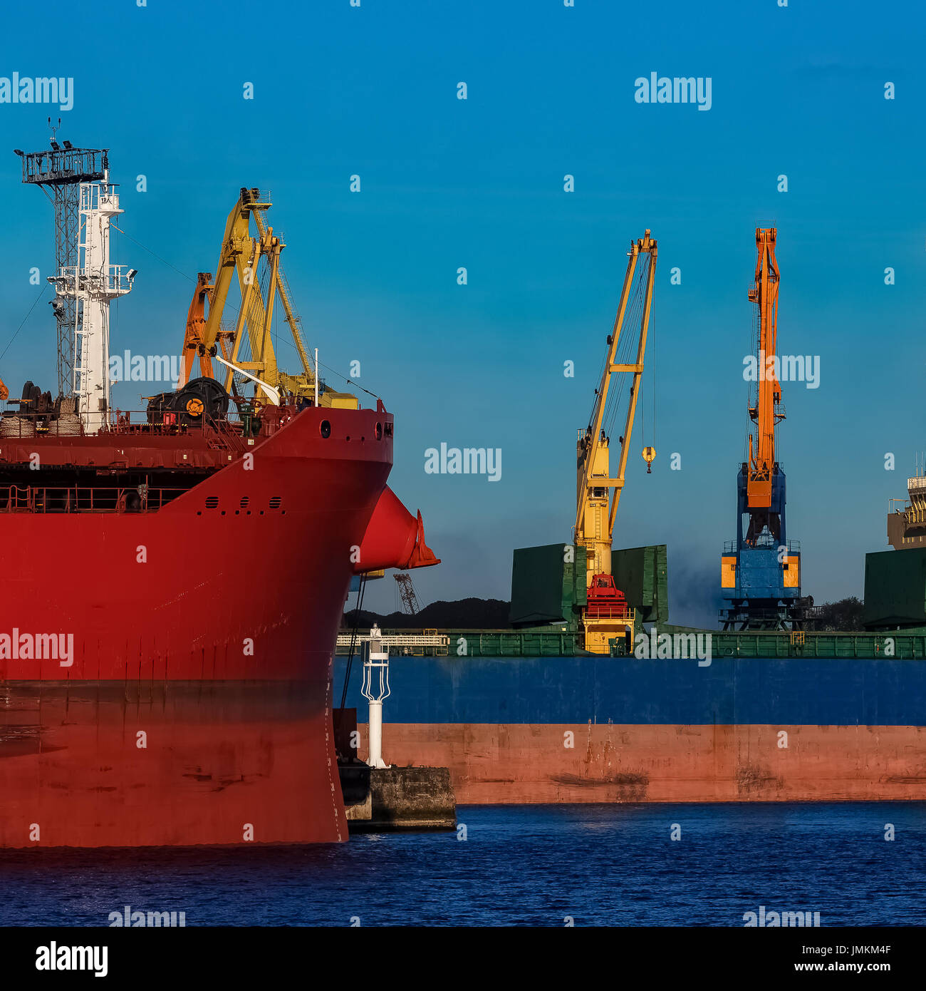 Red and blue cargo ship loading in the port of Riga Stock Photo - Alamy