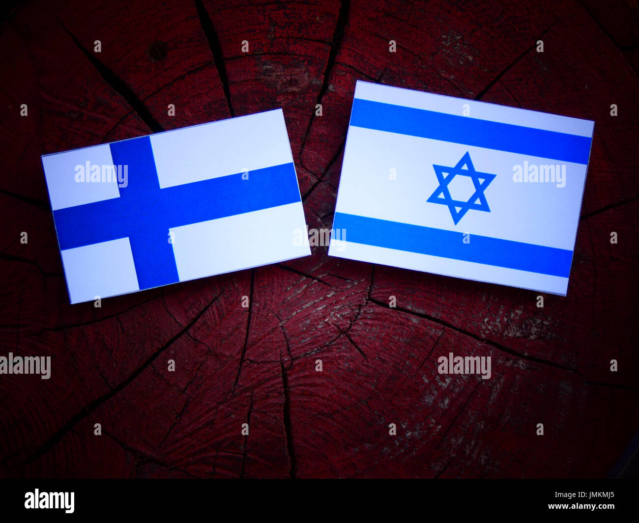 Finnish flag with Israeli flag on a tree stump isolated Stock Photo - Alamy